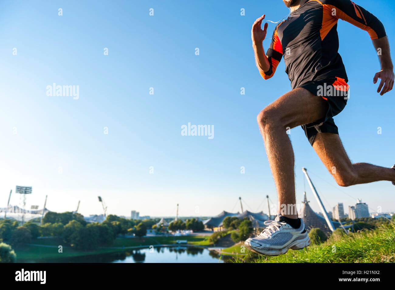 Man running on meadow in park Stock Photo - Alamy