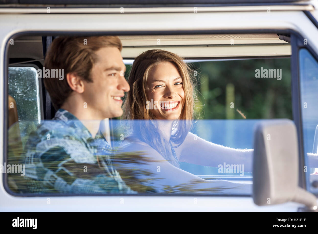 Happy young couple in van Stock Photo - Alamy