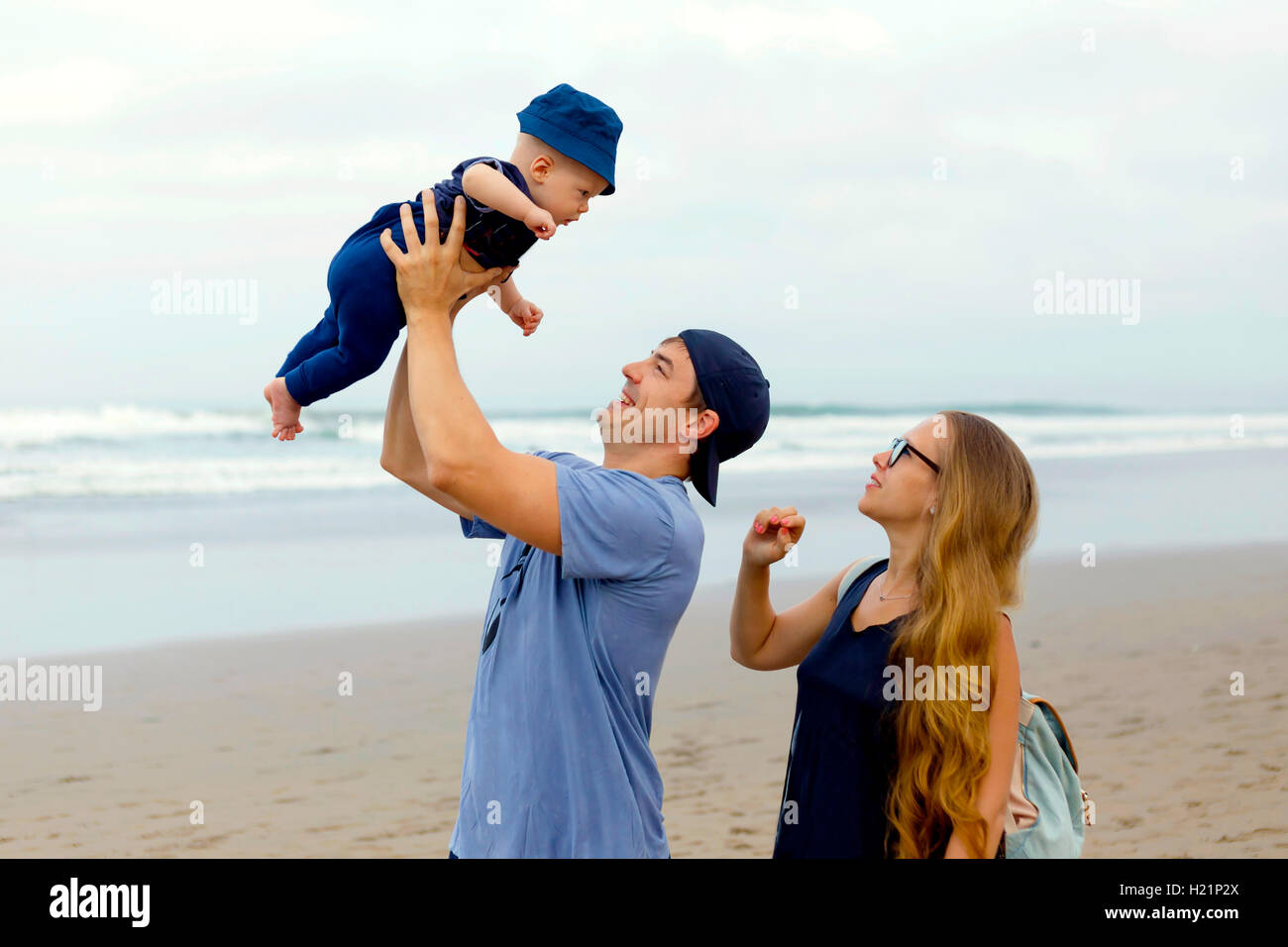 Indonesia, Bali, Happy parents with baby at the beach Stock Photo - Alamy