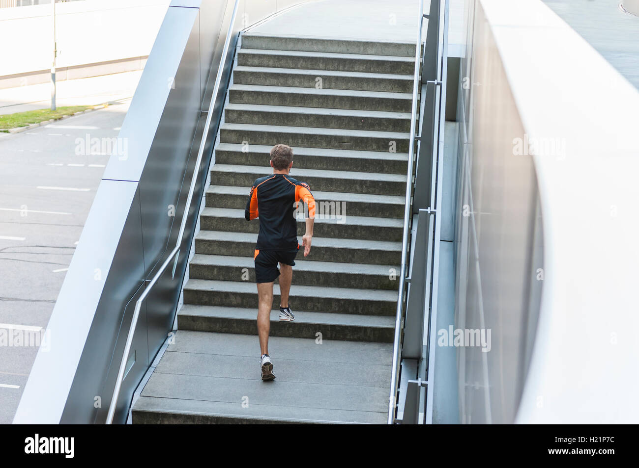 Man running up stairs Stock Photo - Alamy
