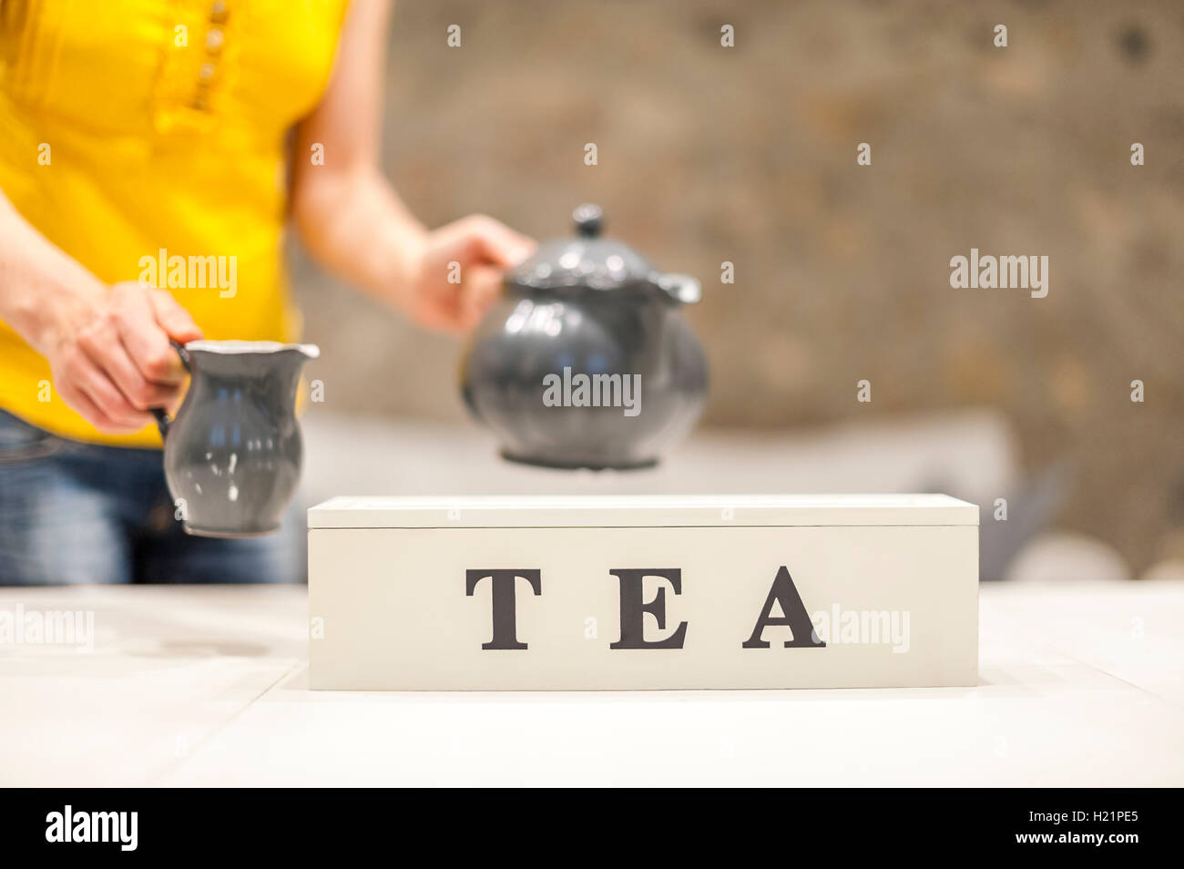 Woman preparing tea Stock Photo - Alamy