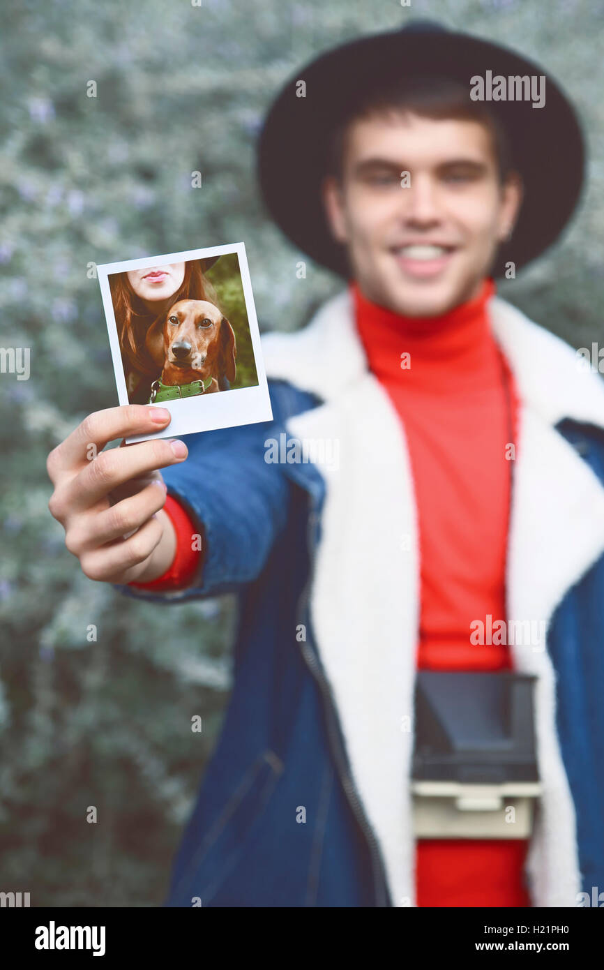 Man showing instant photography outdoors Stock Photo - Alamy