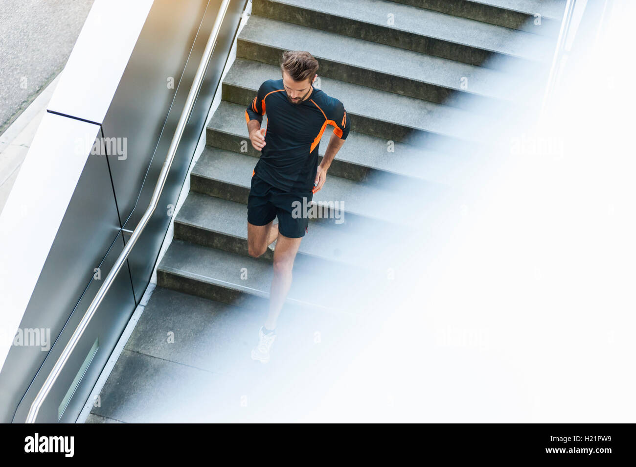 Man running down stairs Stock Photo - Alamy