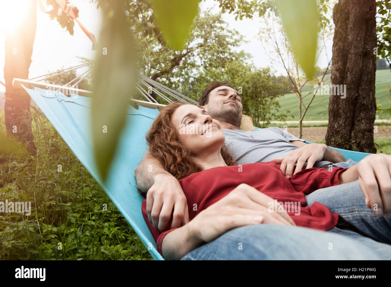 Couple sleeping in hammock hi-res stock photography and images - Alamy