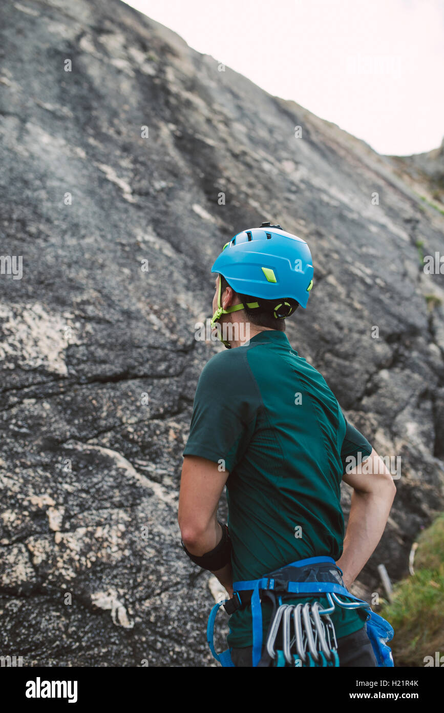 Climber looking up a rock wall Stock Photo - Alamy