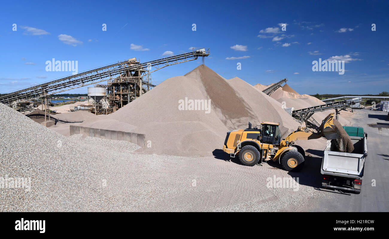Wheel loader loading gravel on truck Stock Photo - Alamy
