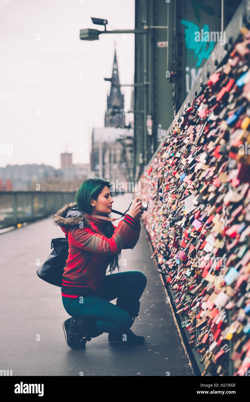 Germany, Cologne, woman taking picture of love locks at Hohenzollern ...