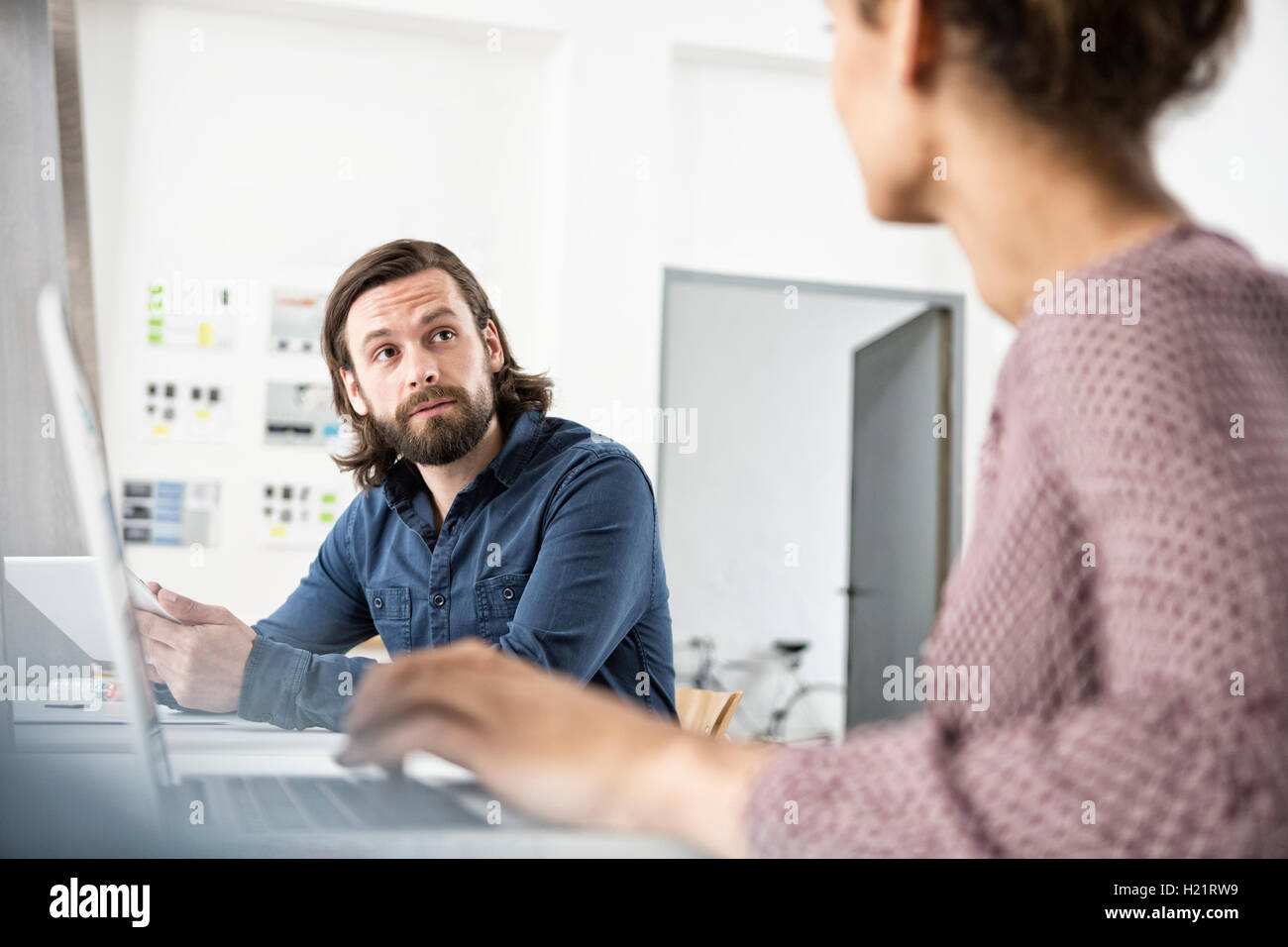 Two colleagues in office facing each other Stock Photo - Alamy