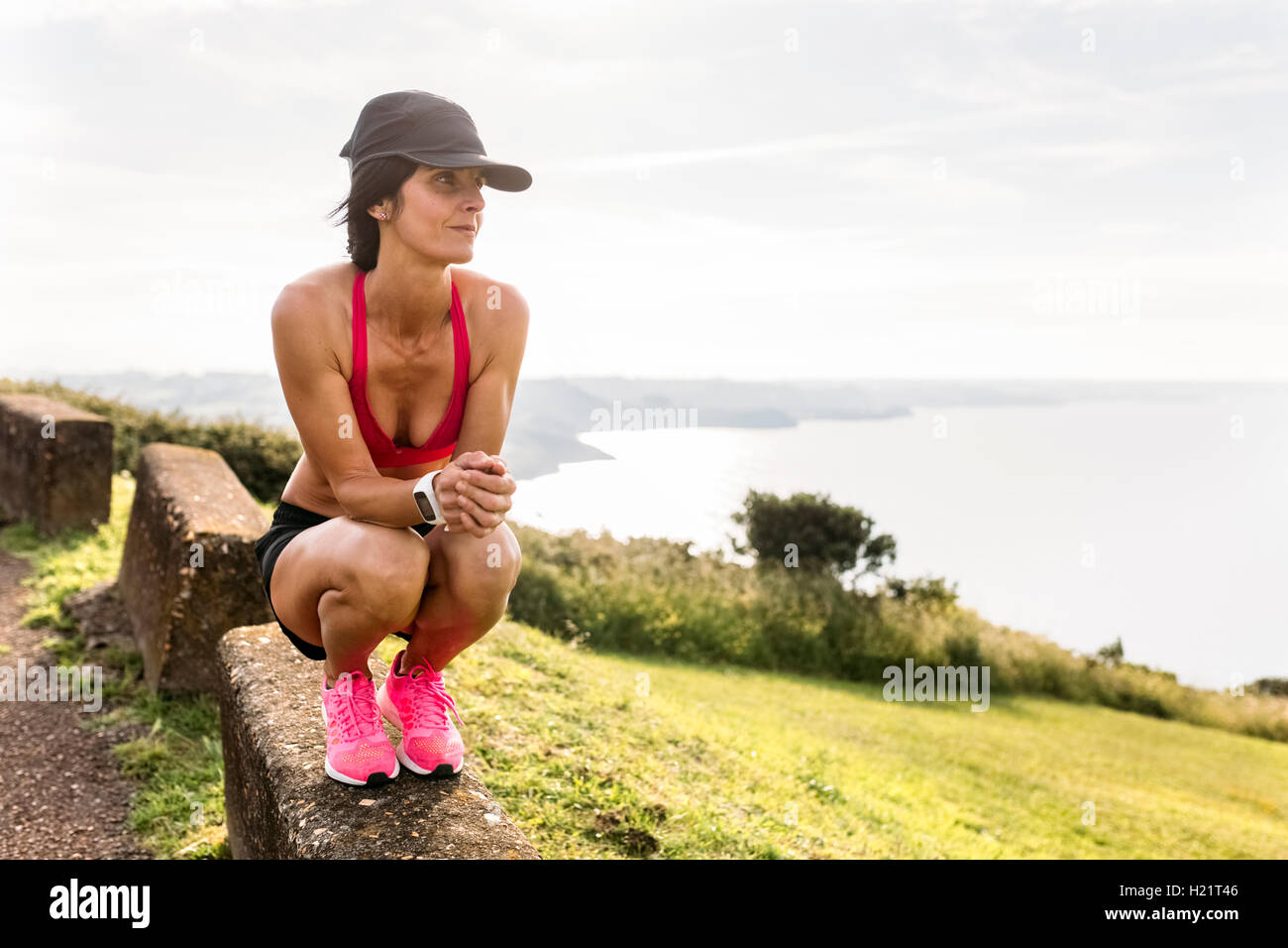 Female athlete taking a rest after workout Stock Photo - Alamy