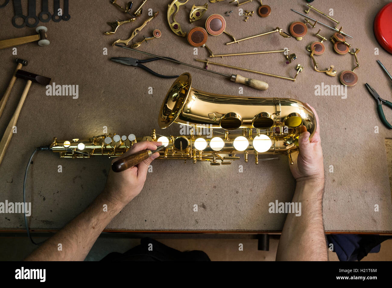 Instrument maker repairing a saxophone Stock Photo - Alamy