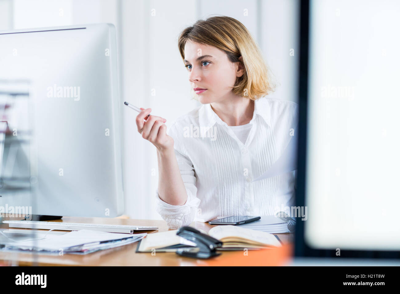 Office worker at desk Stock Photo - Alamy