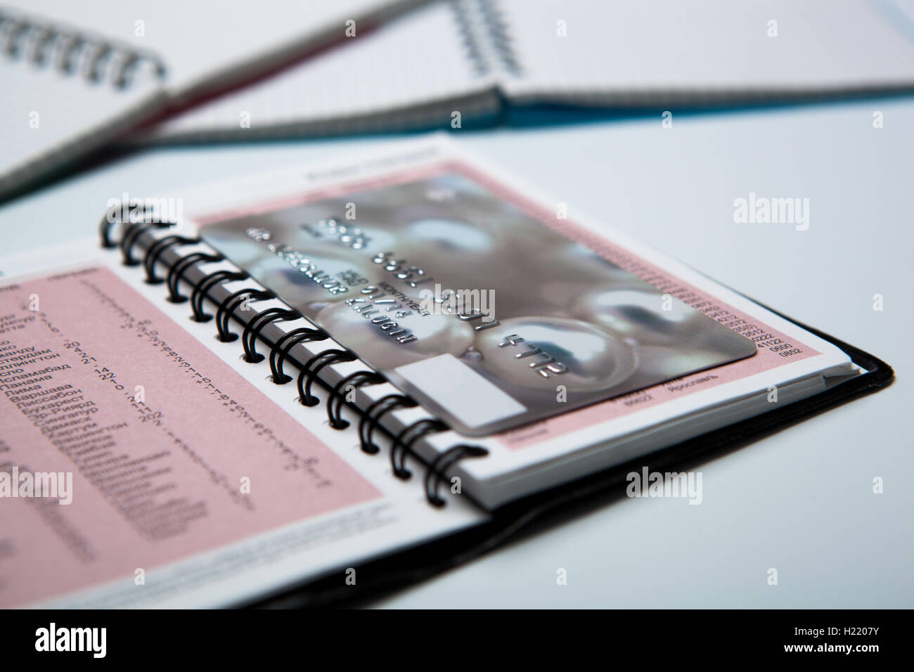 bank card on notebook page with text Stock Photo - Alamy