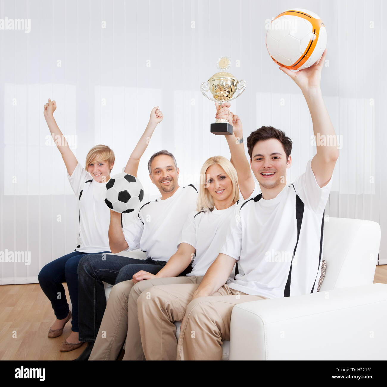 Ecstatic family celebrating a win Stock Photo - Alamy