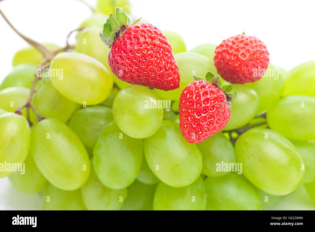 bunch of white grapes and strawberries isolated on white Stock Photo ...