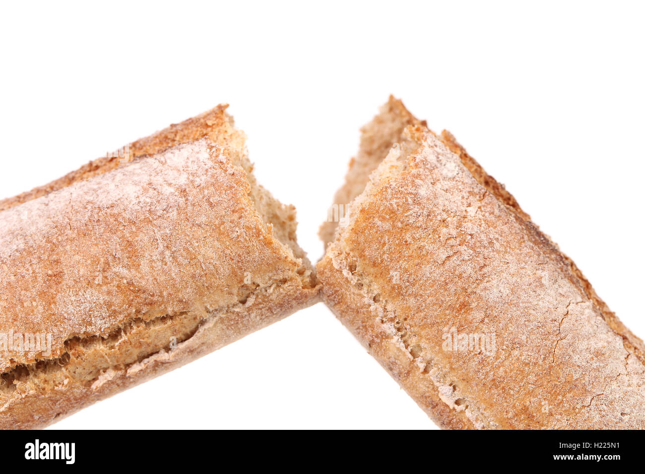 Broken long brown loaf Stock Photo - Alamy