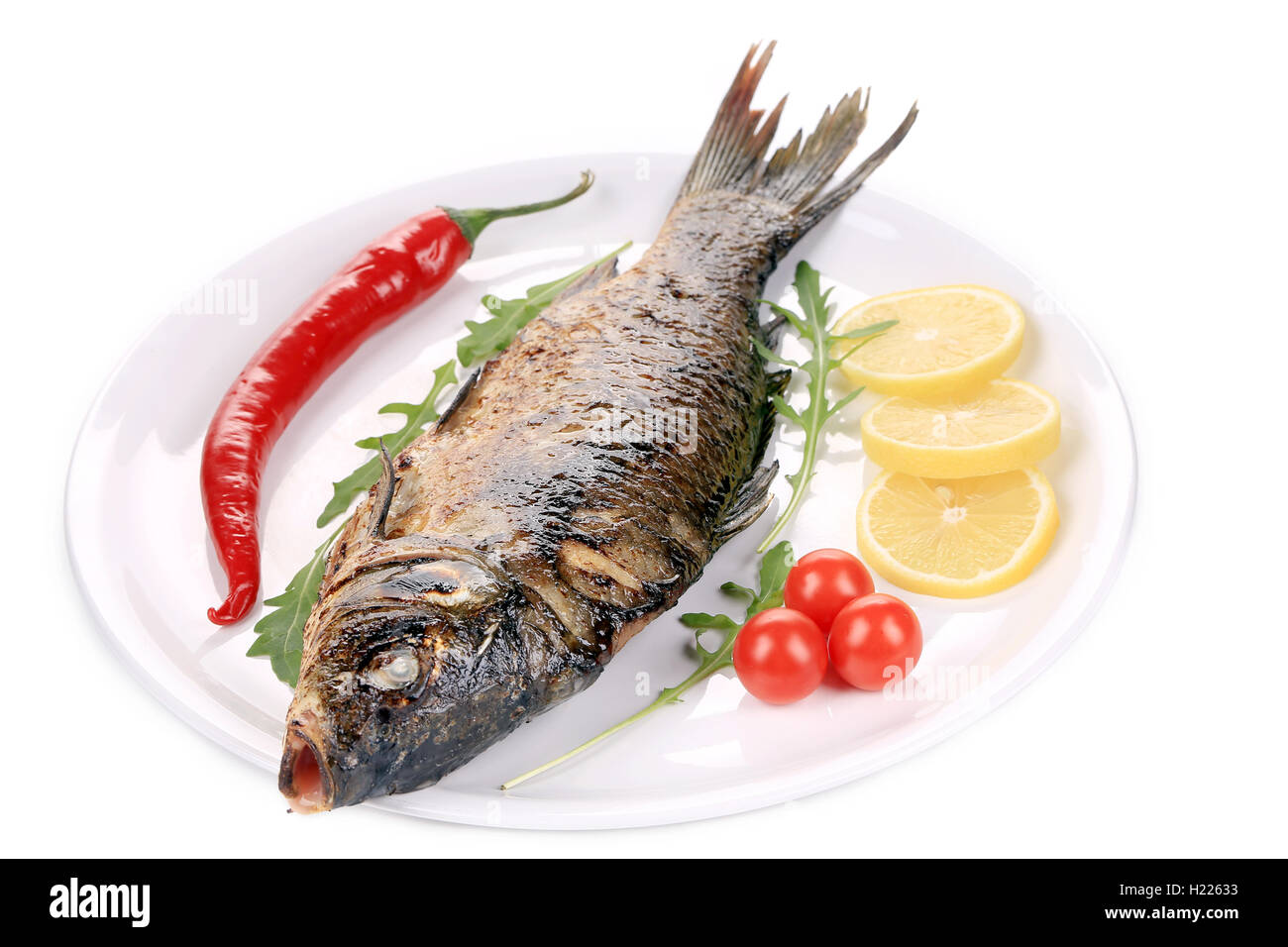Fried fish on a white plate Stock Photo - Alamy