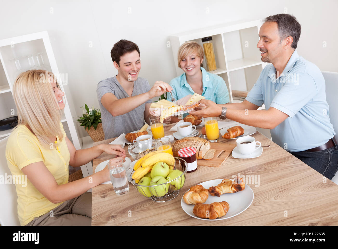 Happy family enjoying breakfast Stock Photo - Alamy