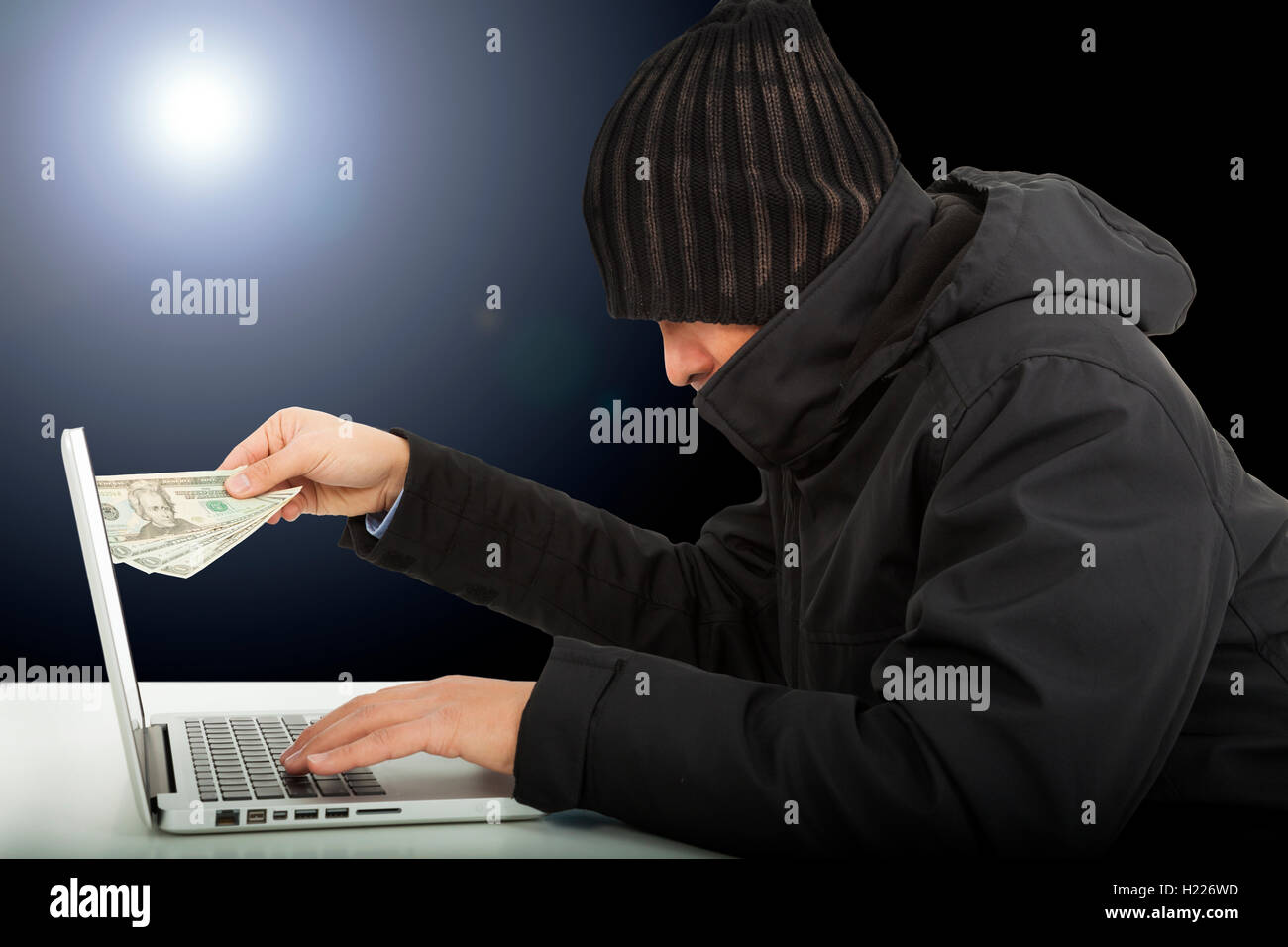 Computer hacker stealing money in the darkness Stock Photo - Alamy