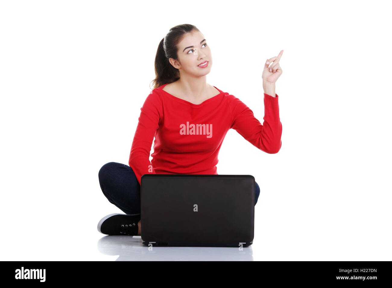 Working on laptop computer and pointing up Stock Photo - Alamy