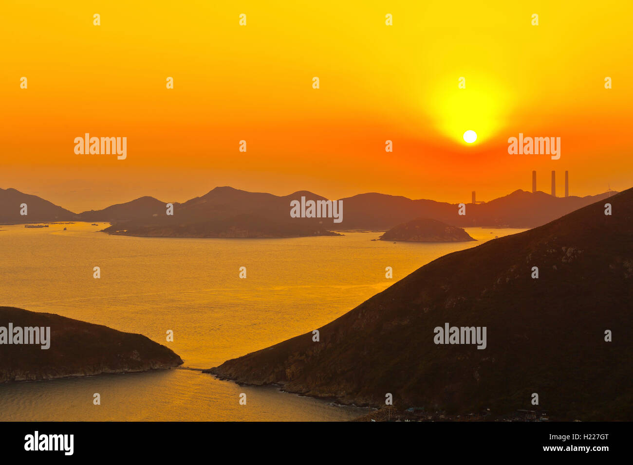 Sunset power plant at coast Stock Photo - Alamy