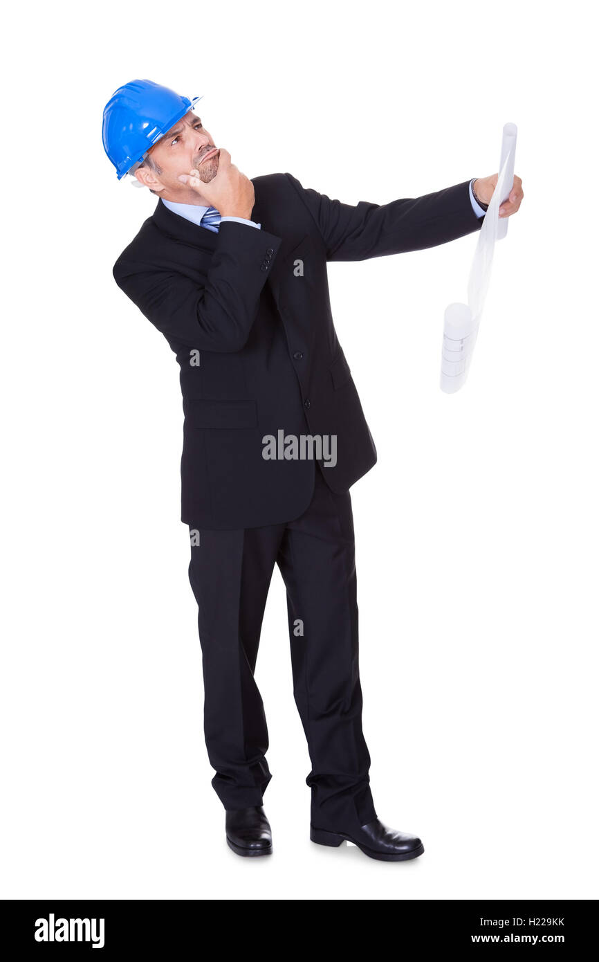 Happy Male Architect Looking At Blueprint Stock Photo - Alamy