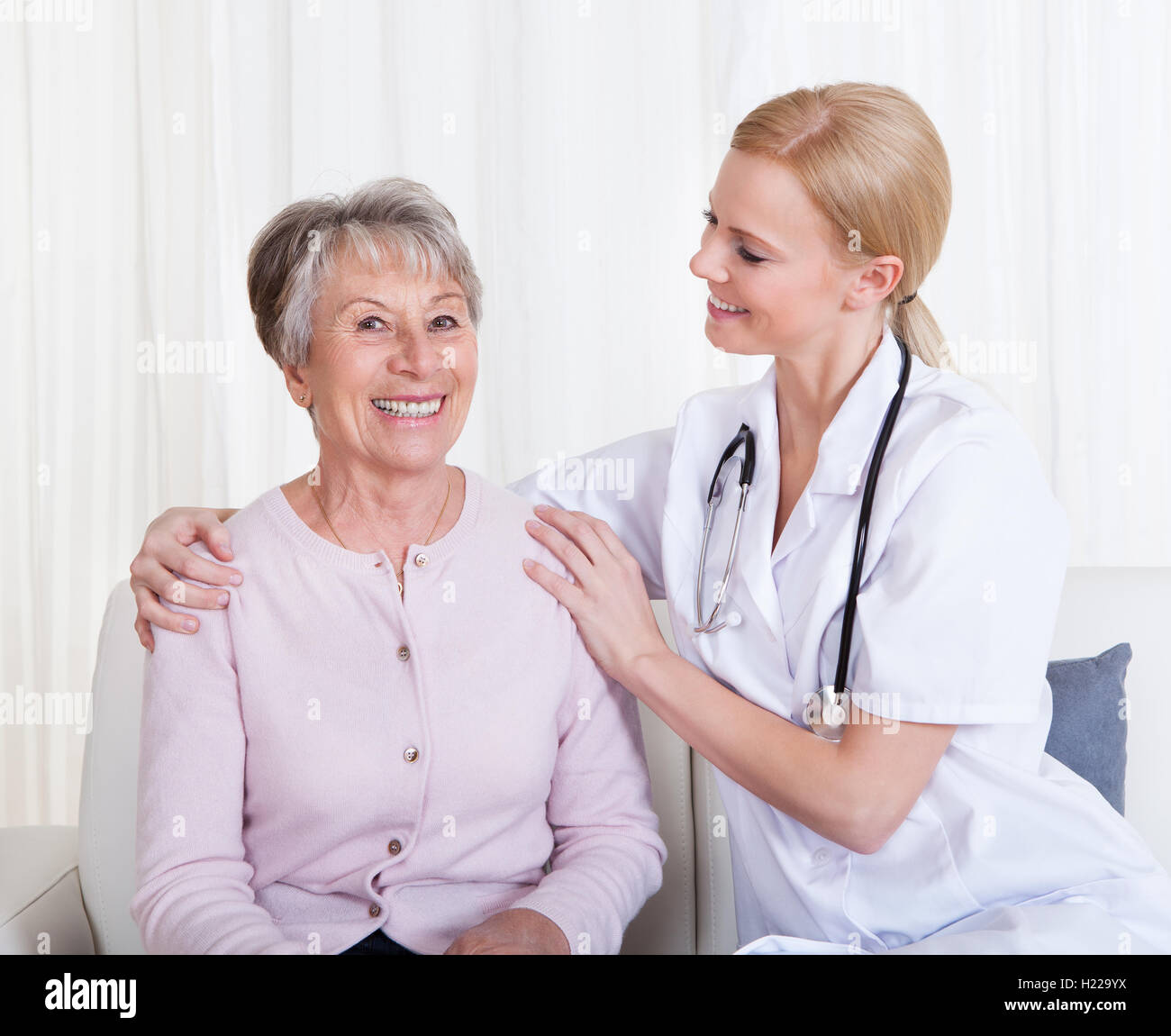 Portrait Of Doctor And Patient Sitting On Couch Stock Photo - Alamy