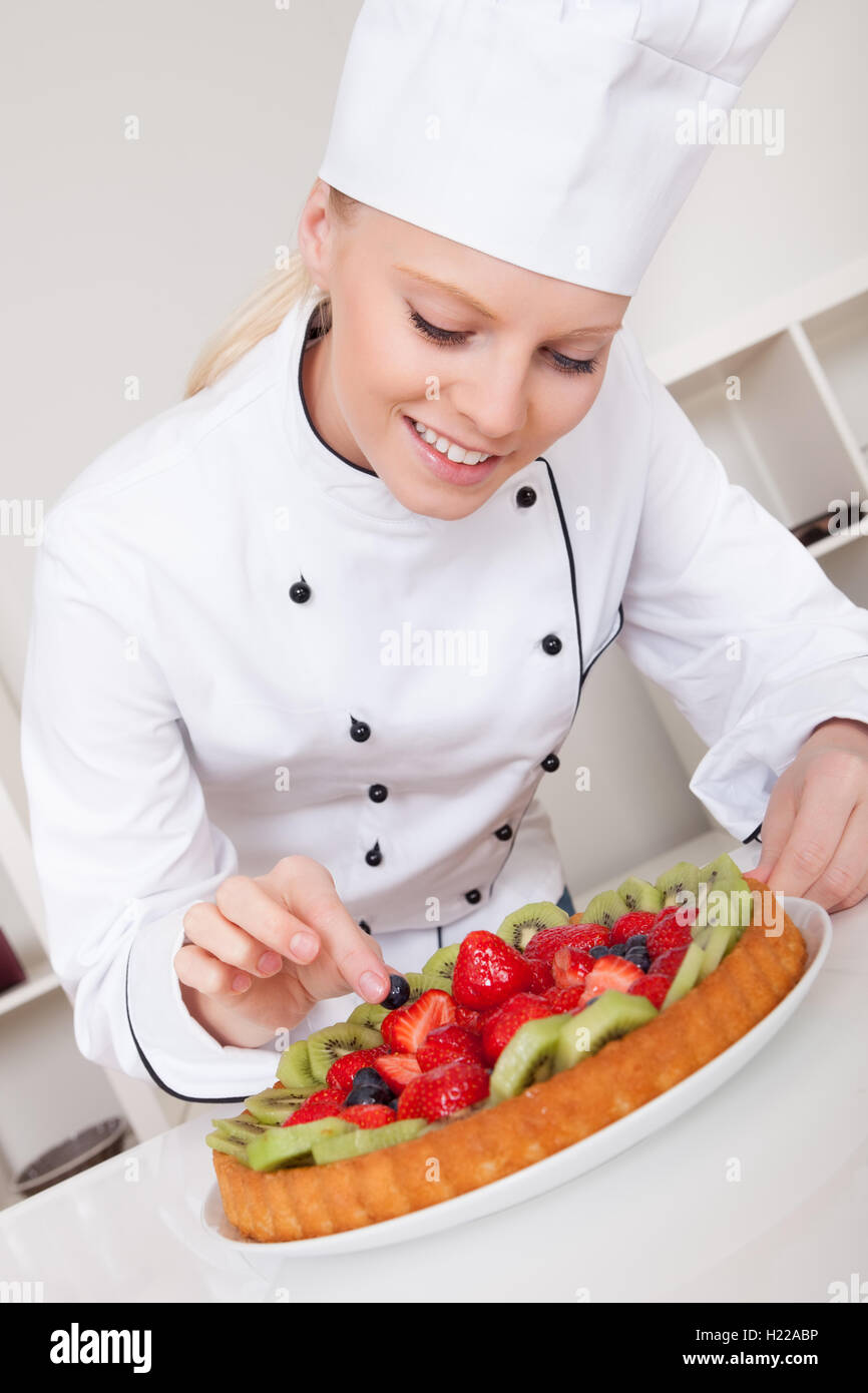 Beautiful chef woman making cake Stock Photo - Alamy