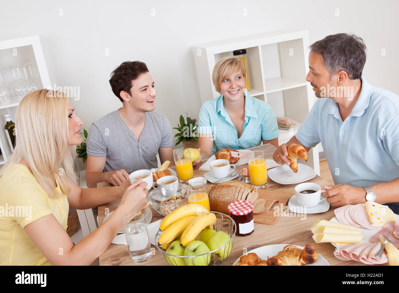 Happy family enjoying breakfast Stock Photo - Alamy