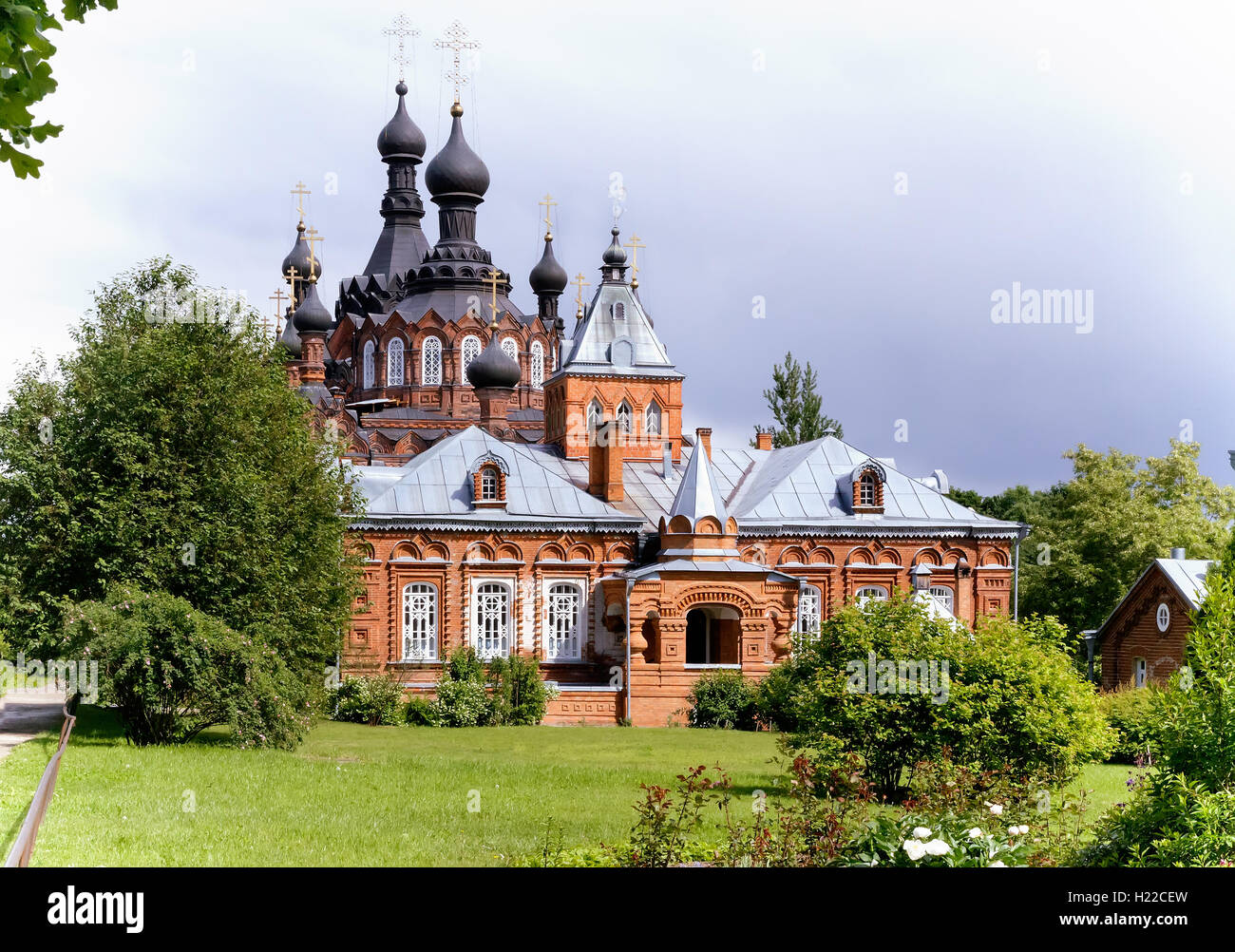 A beautiful Orthodox temple located on a hill surrounded by flowers and ...