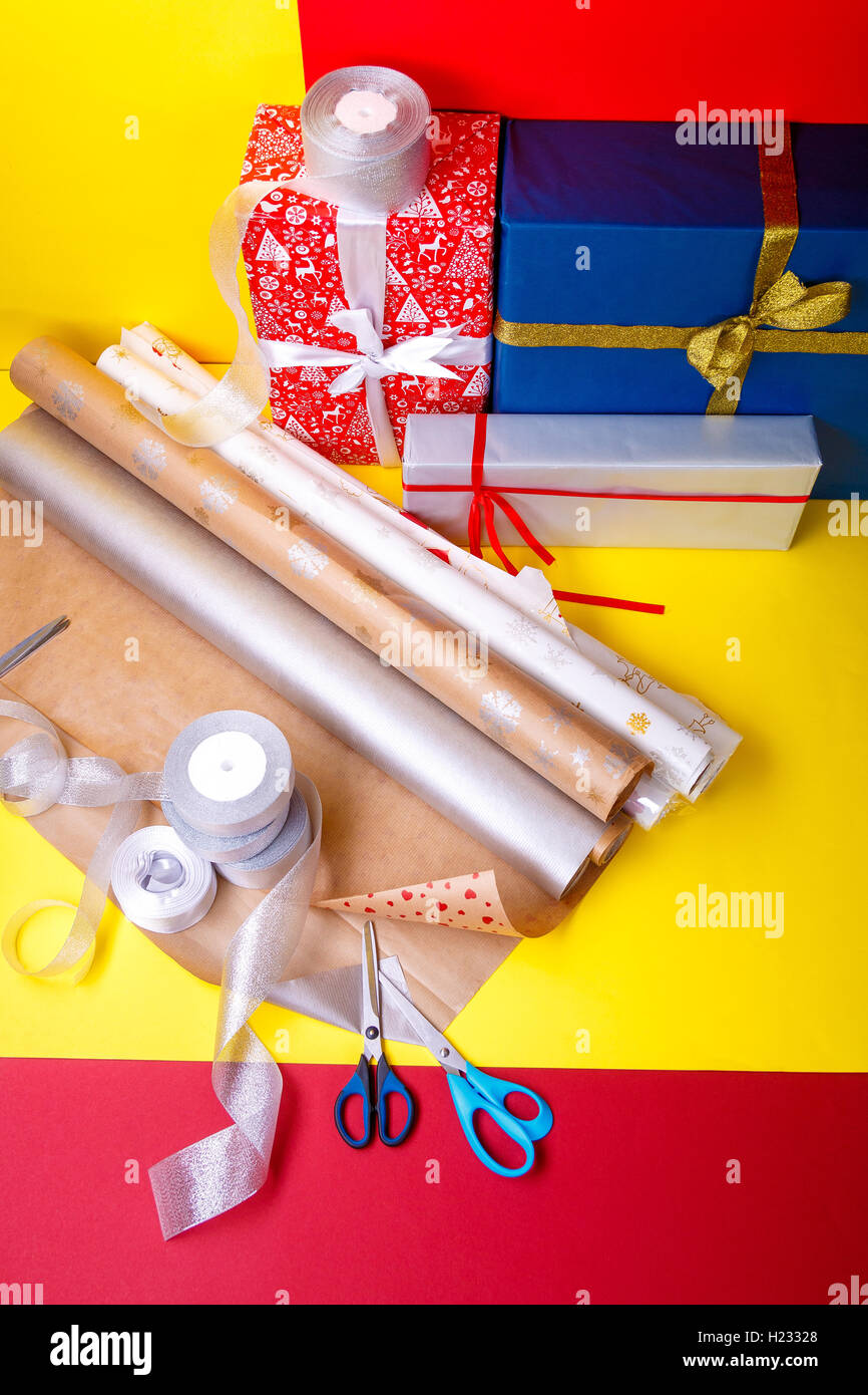 Gift wrapping, boxes, paper, ribbon and scissors on color background ...