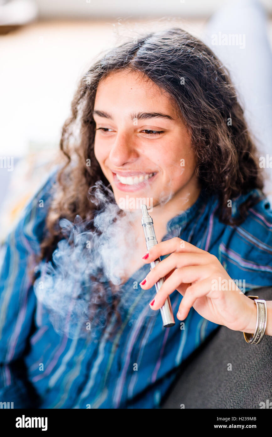 Teenage girl using electronic cigarette Stock Photo - Alamy