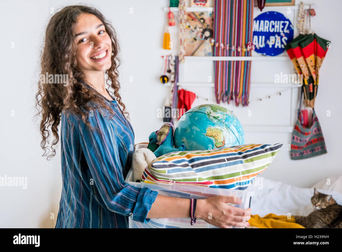 Teenage girl organizing her bedroom Stock Photo - Alamy