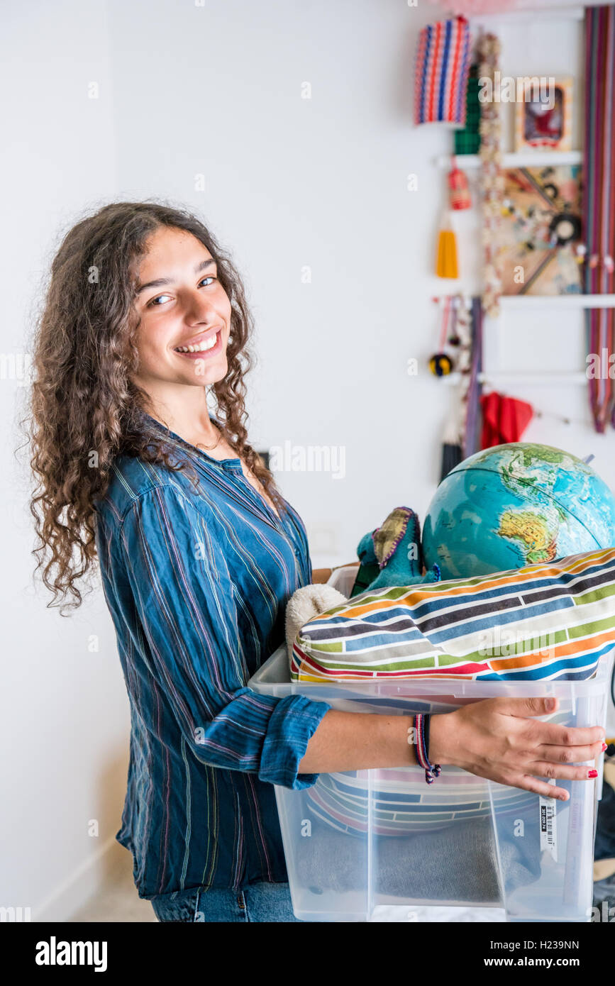Teenage girl organizing her bedroom Stock Photo - Alamy