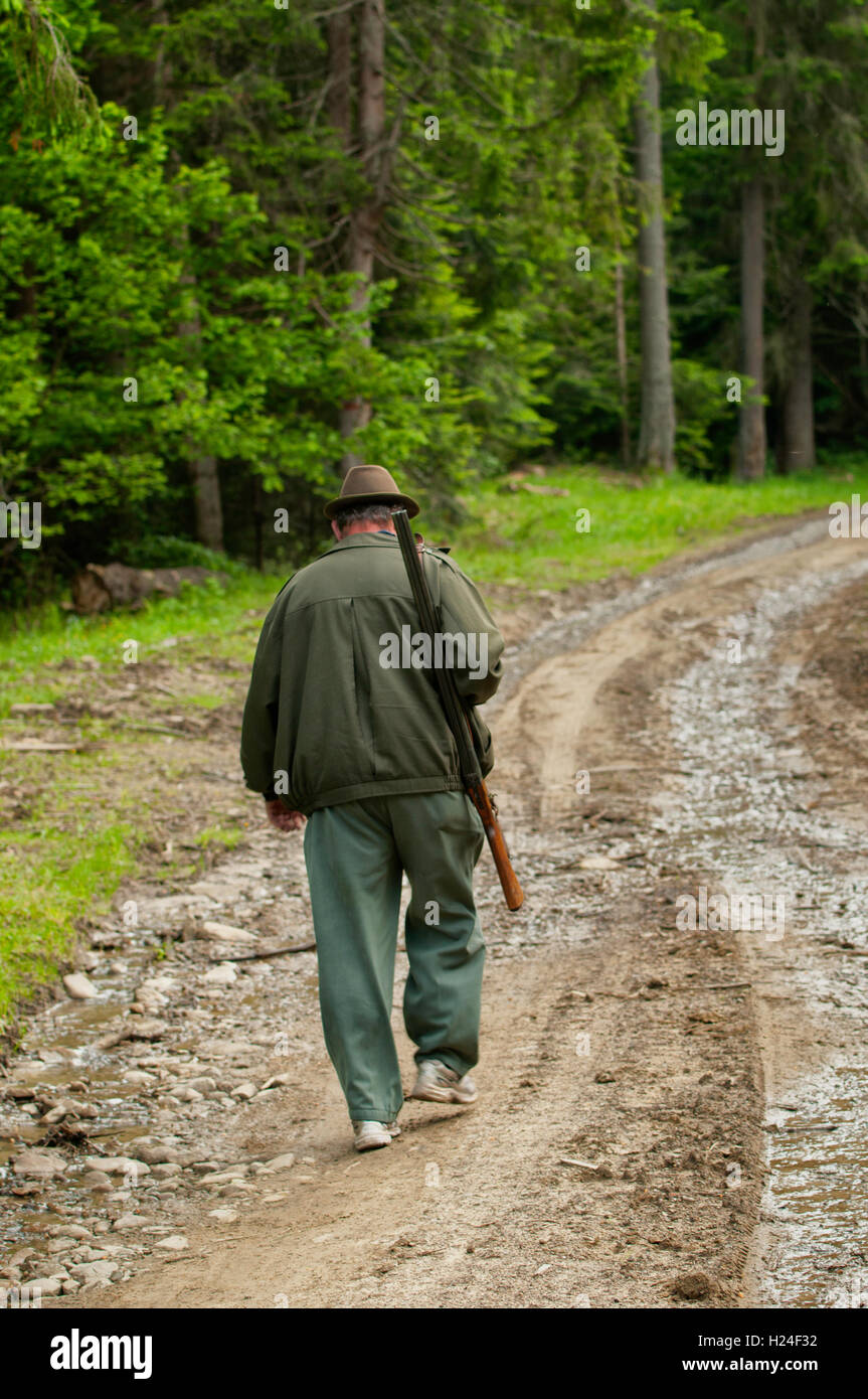 An old hunter walks in Romanian mountains Stock Photo - Alamy
