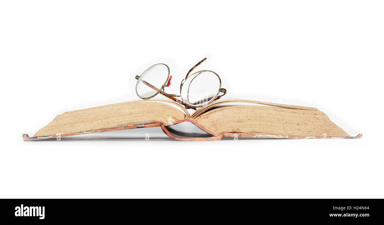 Vintage spectacles on old book against white background Stock Photo - Alamy