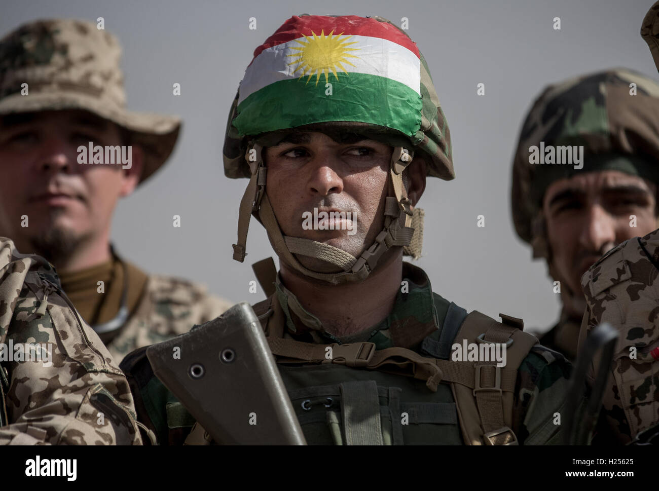 Erbil, Iraq. 23rd Sep, 2016. A Kurdish Peshmerga soldier stands between ...