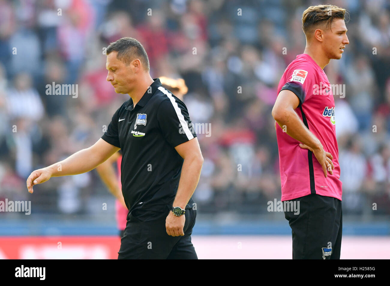 Berlin's coach Pal Dardai (L) walks past Niklas Stark after the German ...
