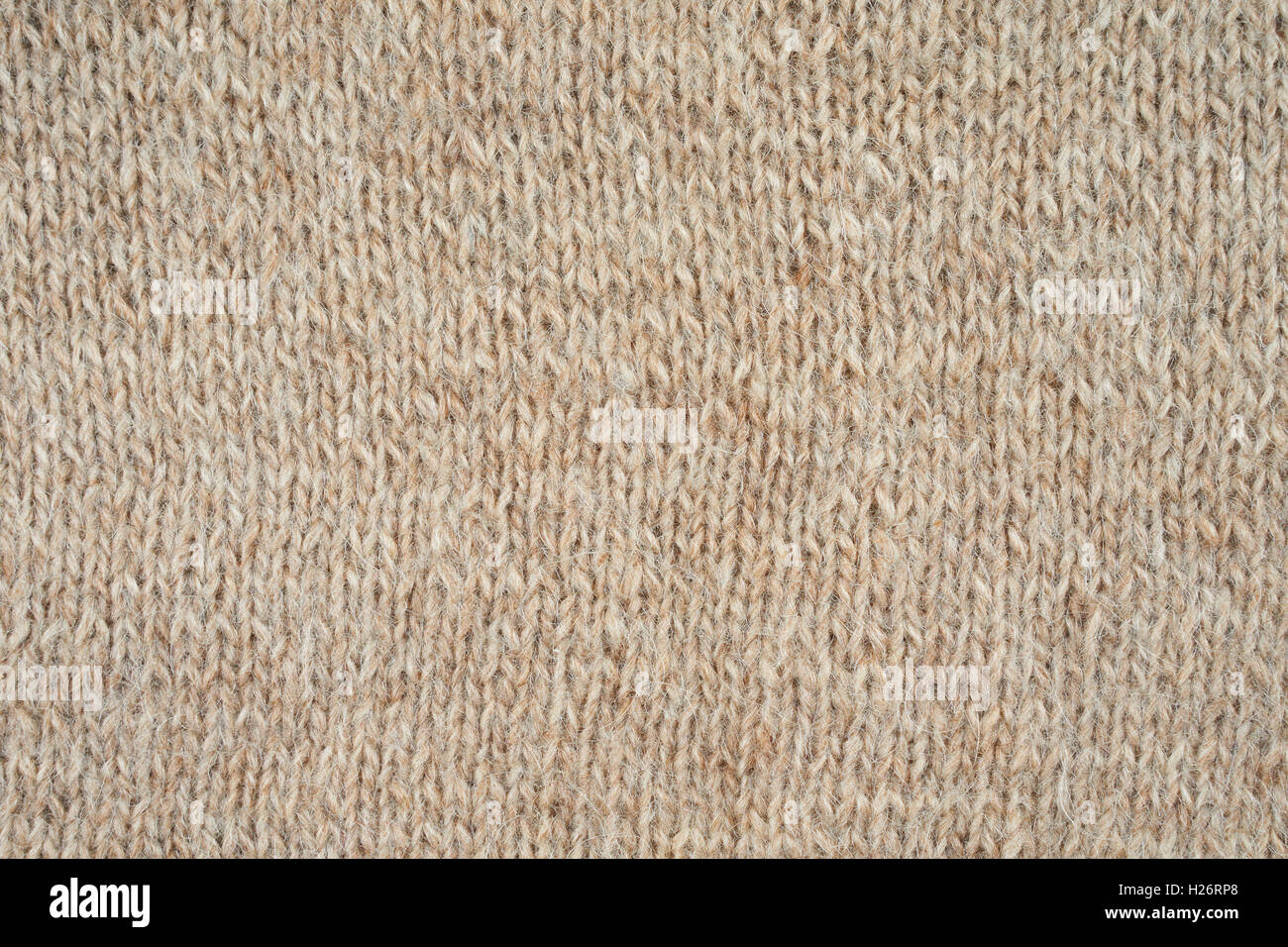 Beige knitted pattern as a seamless background Stock Photo - Alamy