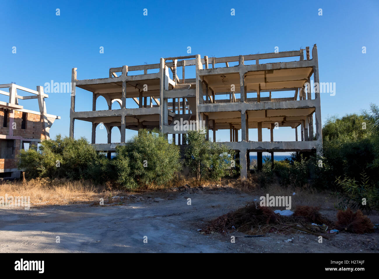 Abandoned half-finished hotel buildings on the seafront at Bogaz in ...