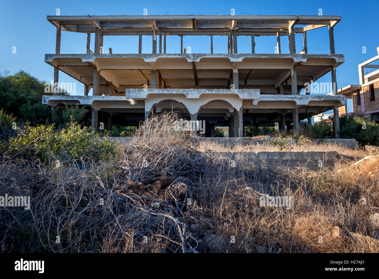 Abandoned half-finished hotel buildings on the seafront at Bogaz in ...