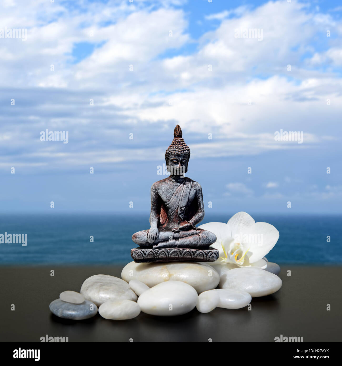 Buddha,zen stone,white orchid flowers and sky background Stock Photo ...