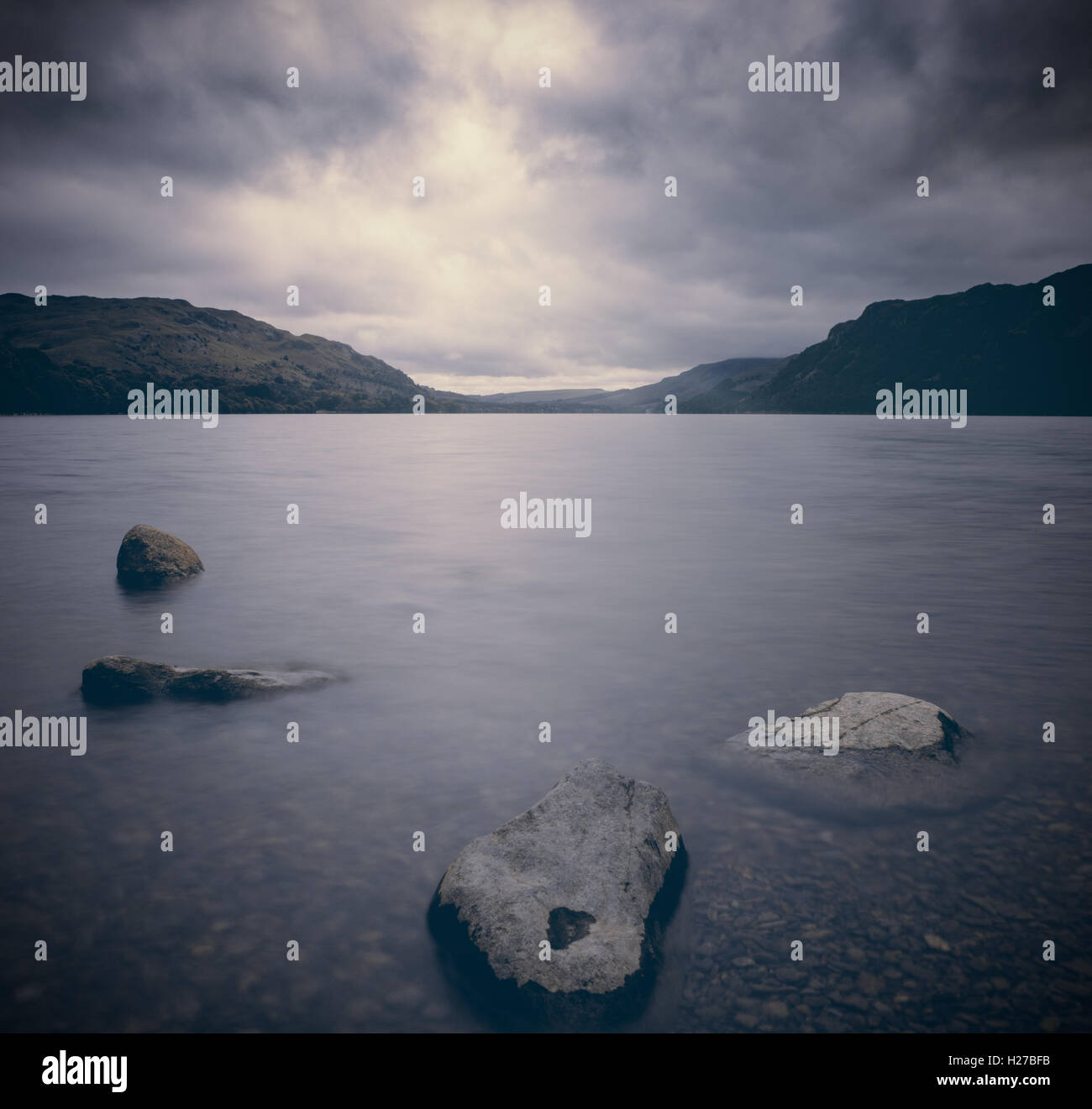 Moody Lake Shore Landscape with Stones Submerged in Water Stock Photo ...