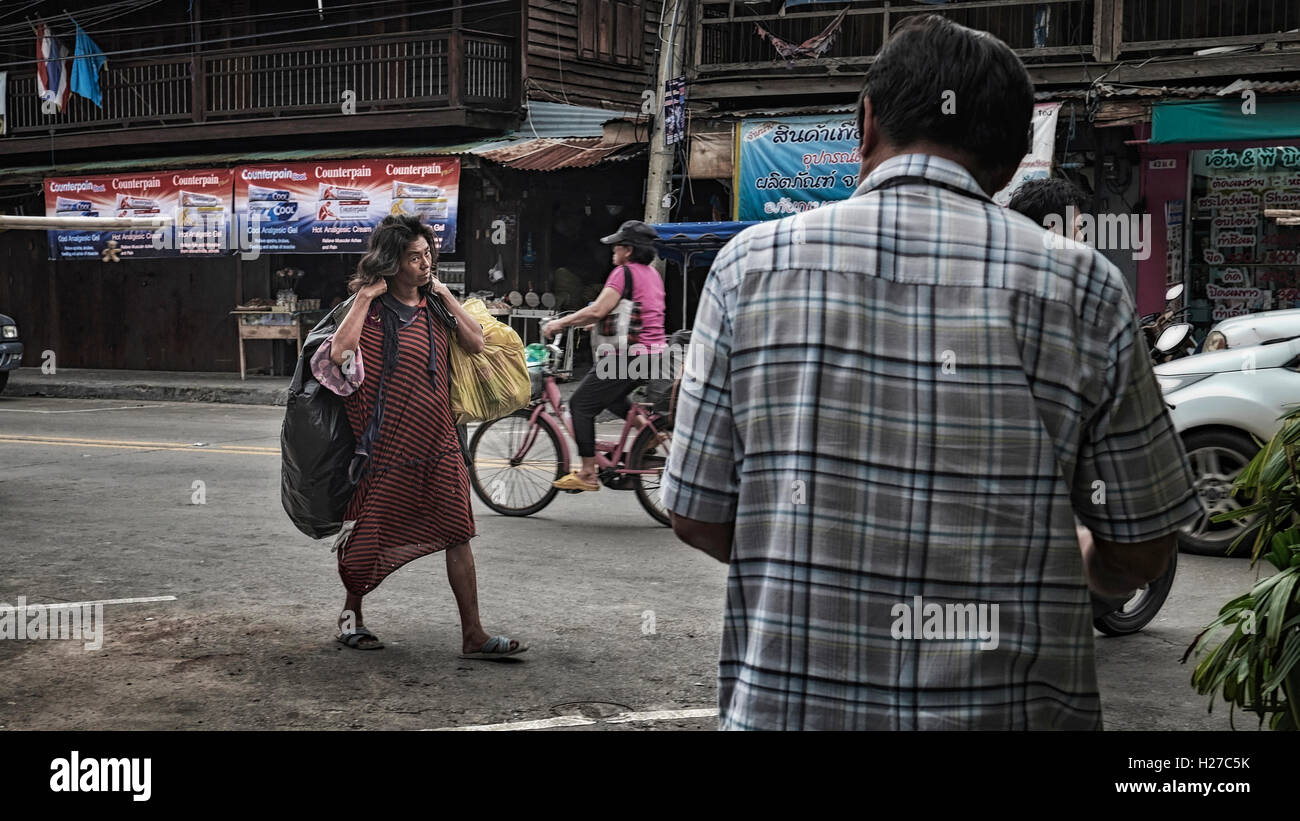 Homeless person. Asian woman walking the streets with her belongings ...