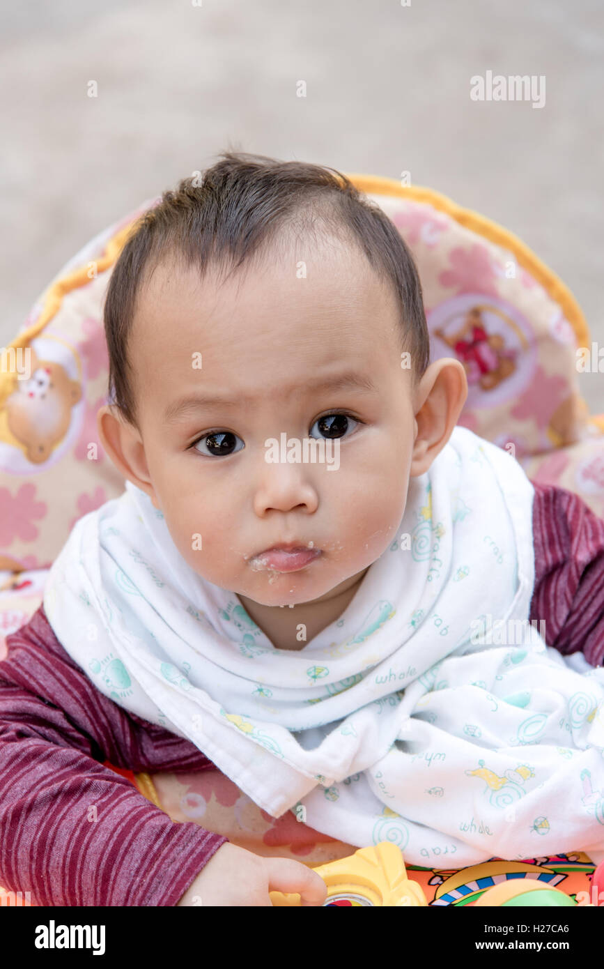 Baby eating food by mother feeding, family scene of Thailand Stock ...