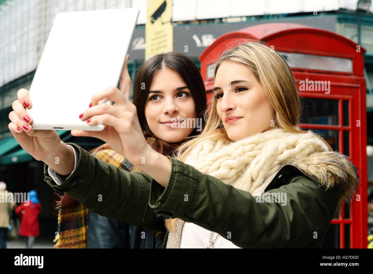 Portrait Of Two Young Girlfriends Taking Selfie With Tablet On A Trip Together Tourism Concept