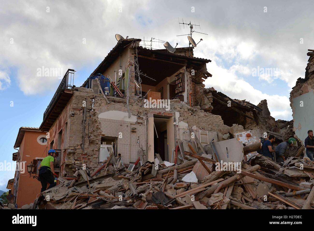 Rescuers clear debris while searching for victims in damaged buildings ...