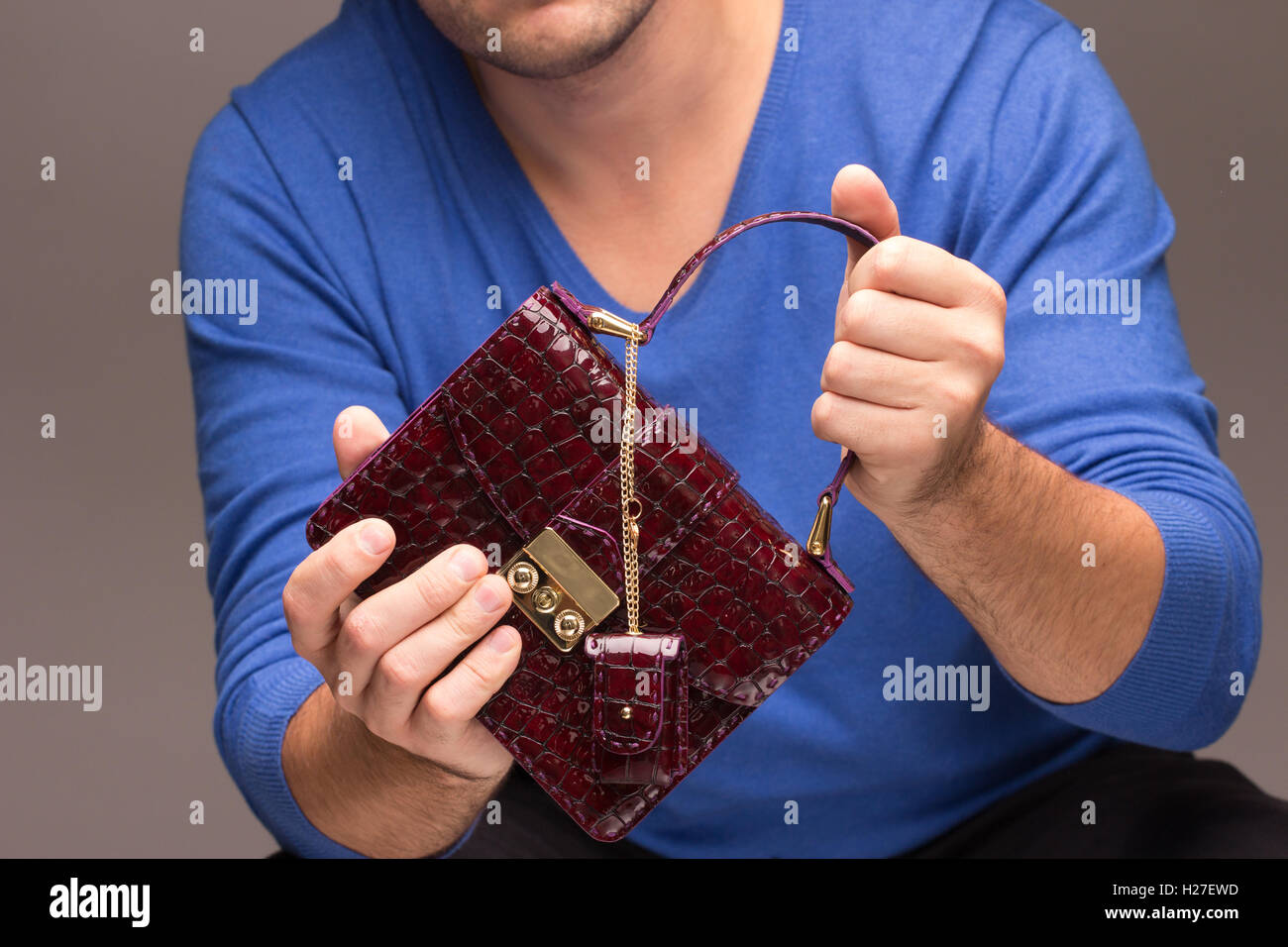 Modern blue bag in male hands Stock Photo - Alamy