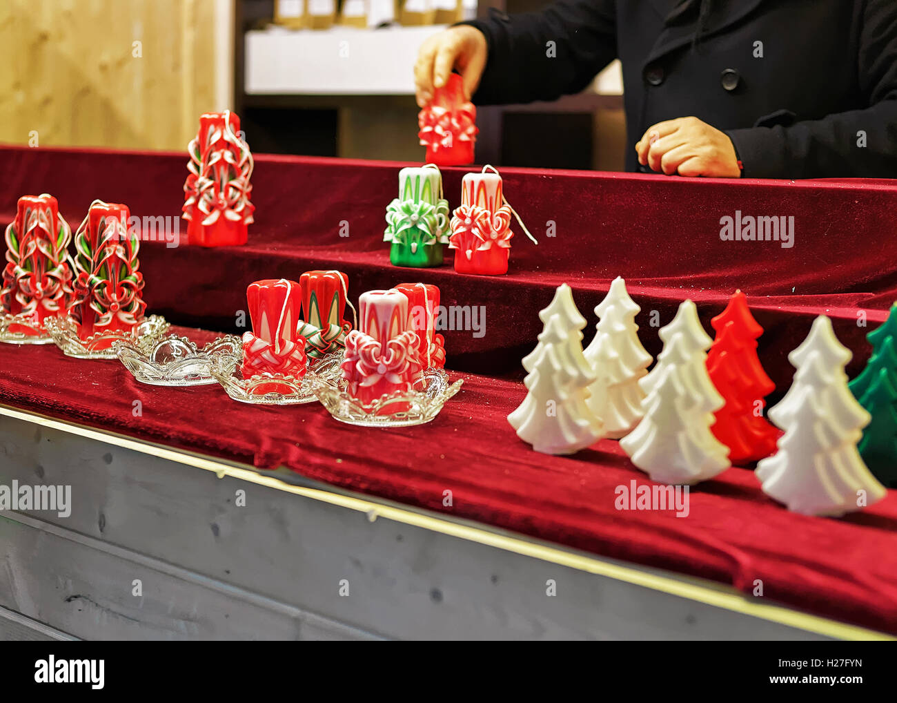 Festive colorful wax candles and the seller at the Christmas Market in ...