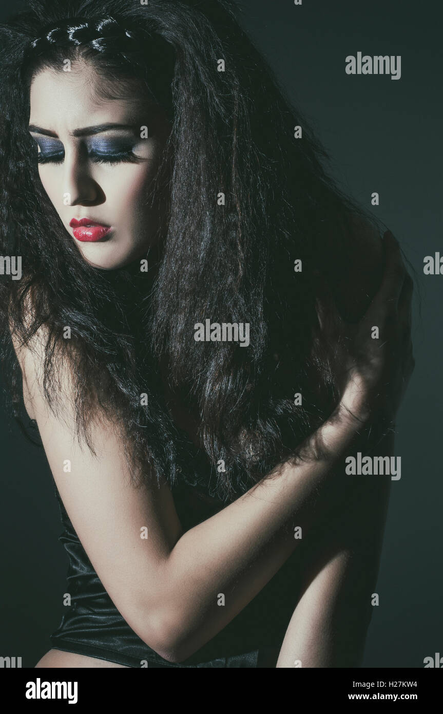 Sad beautiful woman with makeup Stock Photo - Alamy