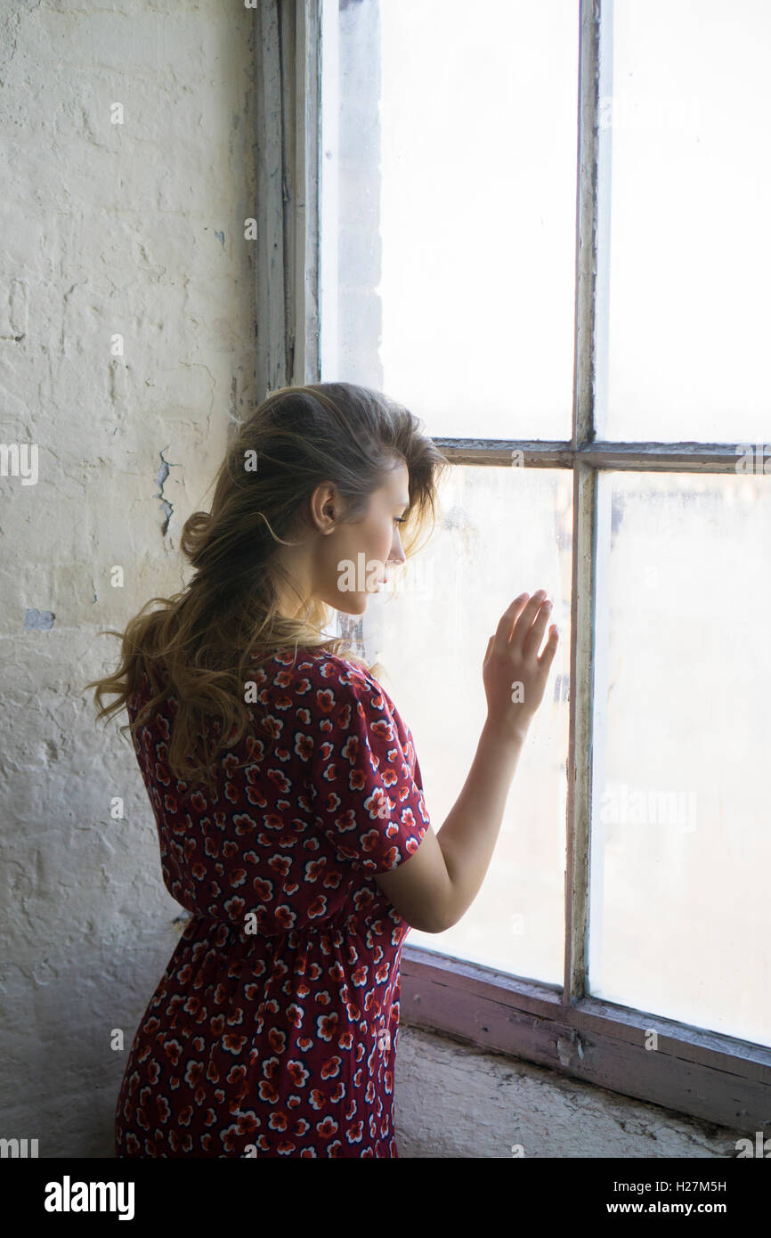 Profile of a serious woman looking out of the window Stock Photo - Alamy